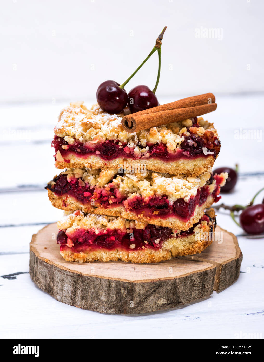 pile of baked cake with cherry, close up Stock Photo - Alamy