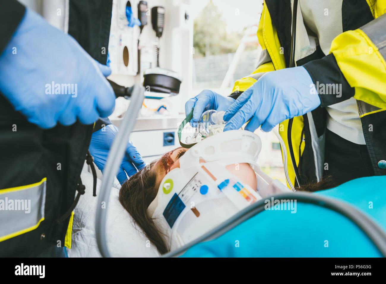Emergency doctor taking care of seriously injured woman Stock Photo - Alamy