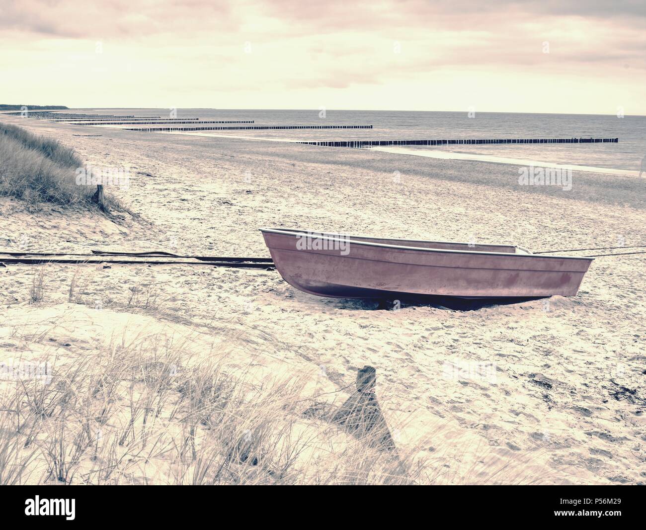 Small wrecked ship, wooden boat anchored at the sea, moody morning ...