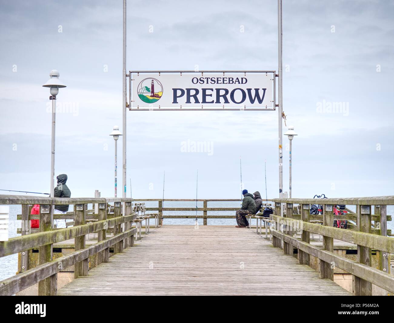 Prerow Germany - June 25 2018: Fisherman on wooden sea bridge. Typical ...