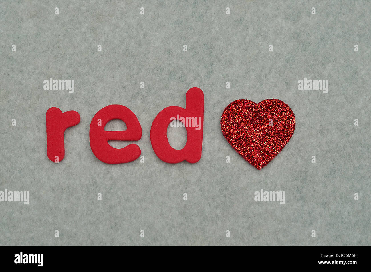 The word red with a red heart on a white background Stock Photo - Alamy