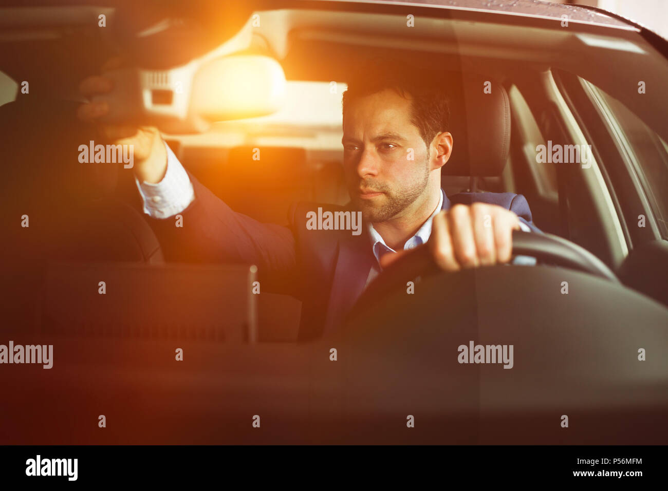 Man driving car adjusting mirrors Stock Photo - Alamy