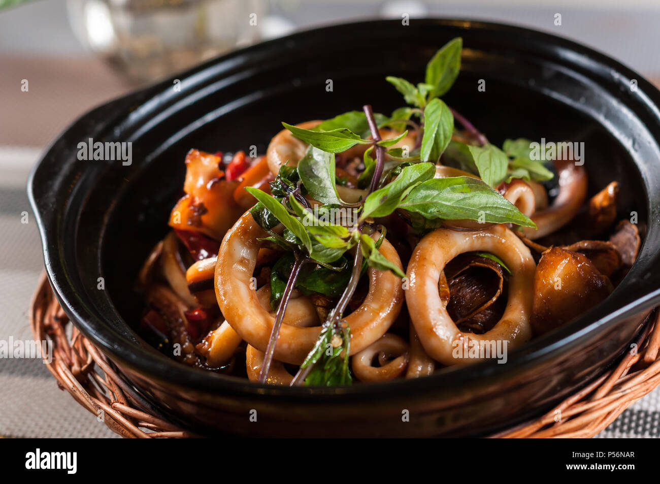 Using three cups of special cooking squid sauce Stock Photo - Alamy