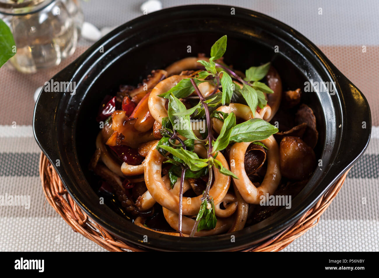 Using three cups of special cooking squid sauce Stock Photo - Alamy