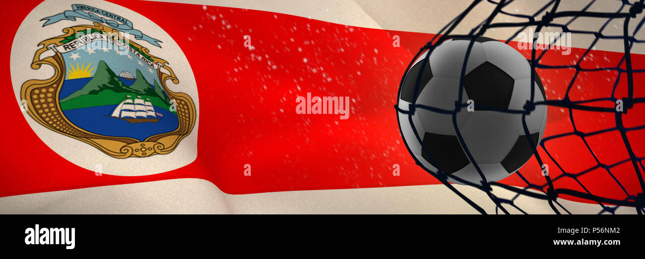 Composite image of football hitting the back of the net Stock Photo - Alamy