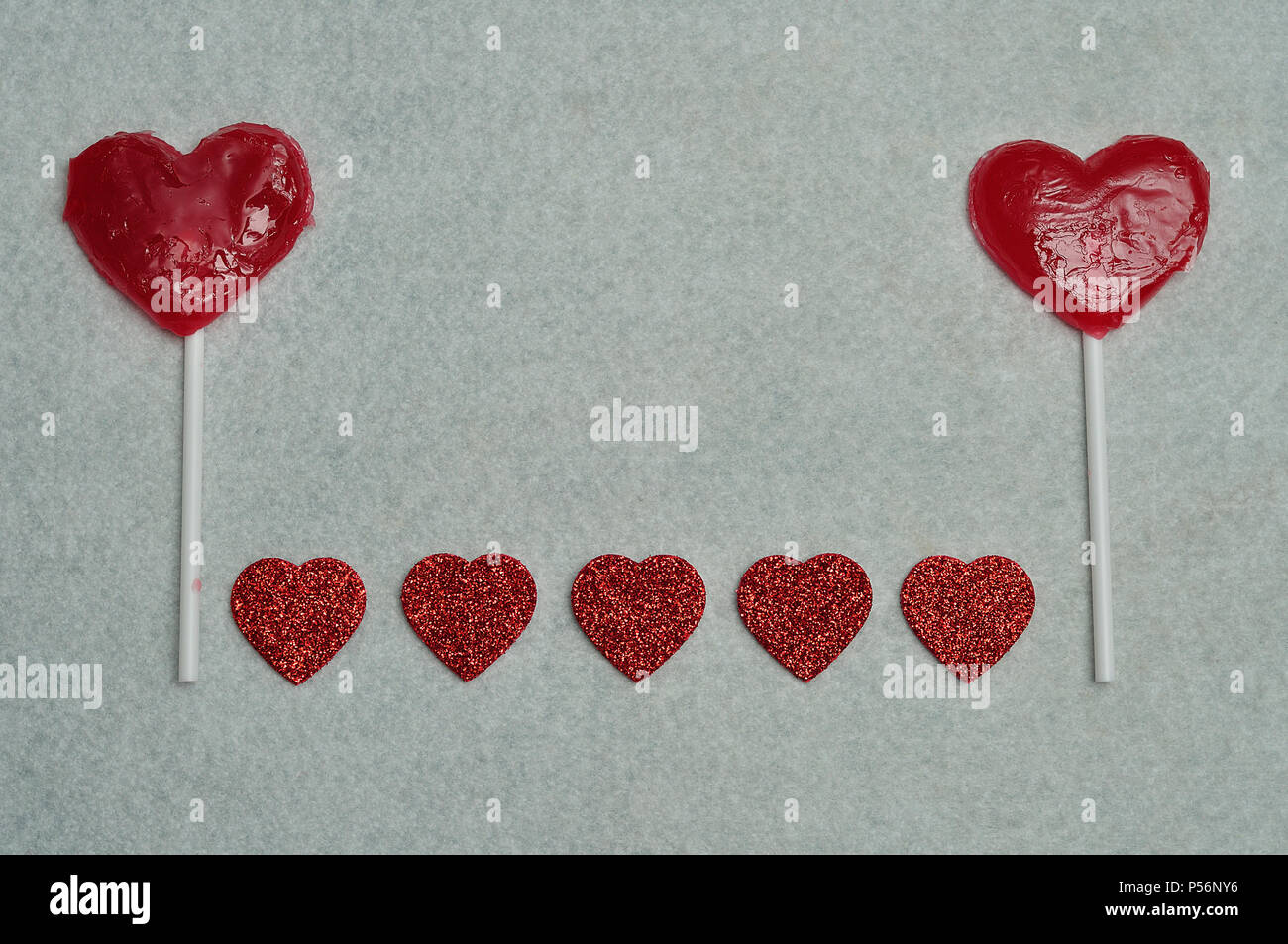 Two heart shape lollipops displayed with a row of glitter hearts Stock ...