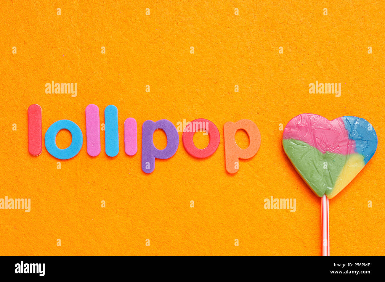 The word lollipop with a colorful heart shape lollipop Stock Photo - Alamy
