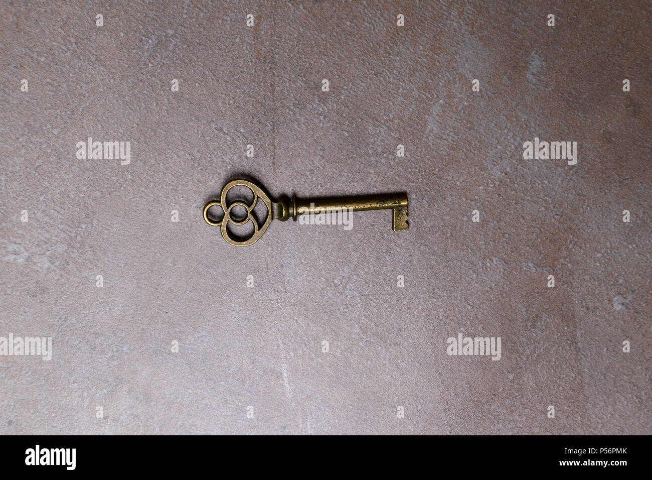 Old retro rusty door key front grey wall background. Vintage style ...