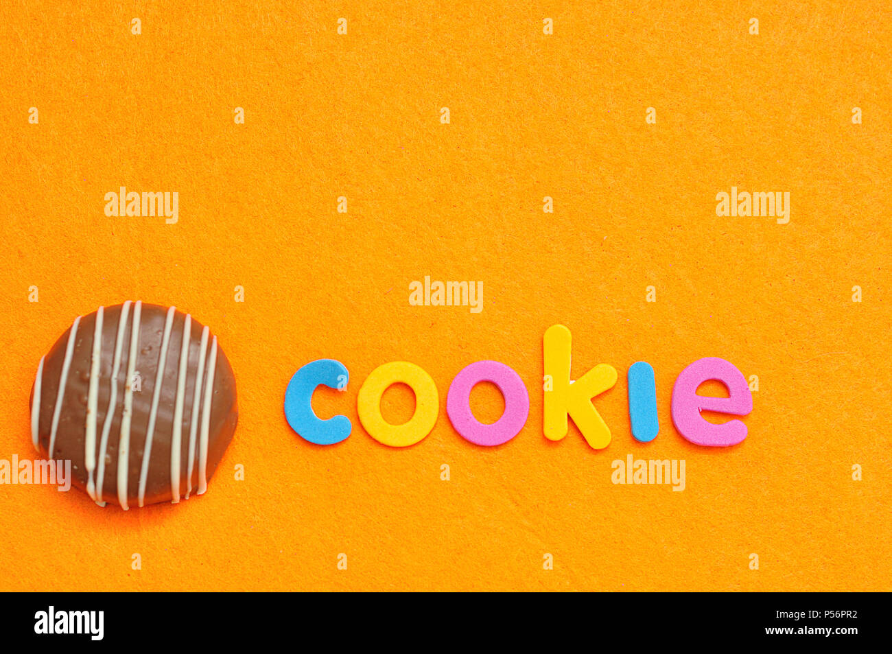 The word cookie with a chocolate covered shortbread cookie Stock Photo ...