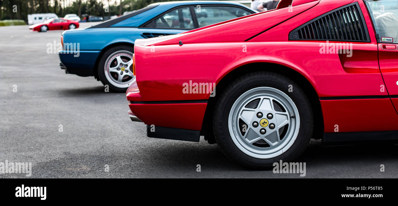 A classic red Ferrari 328 GTS sports car and a blue Ferrari mondial ...