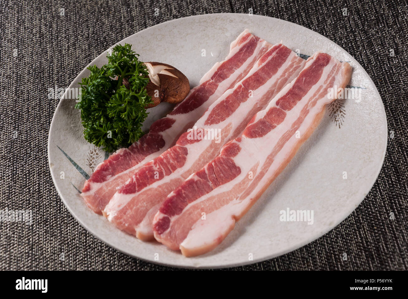 fresh streaky pork in a white dish Stock Photo - Alamy