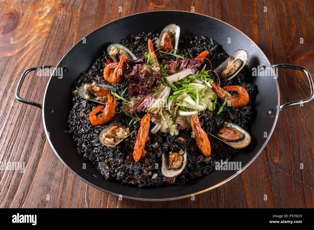 Paella,Seafood with black rice Stock Photo - Alamy
