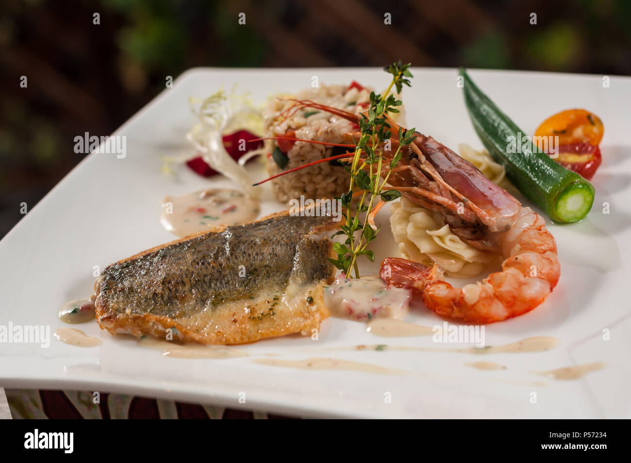 Pan fry sea bass filet and red king prawn with rice Stock Photo - Alamy