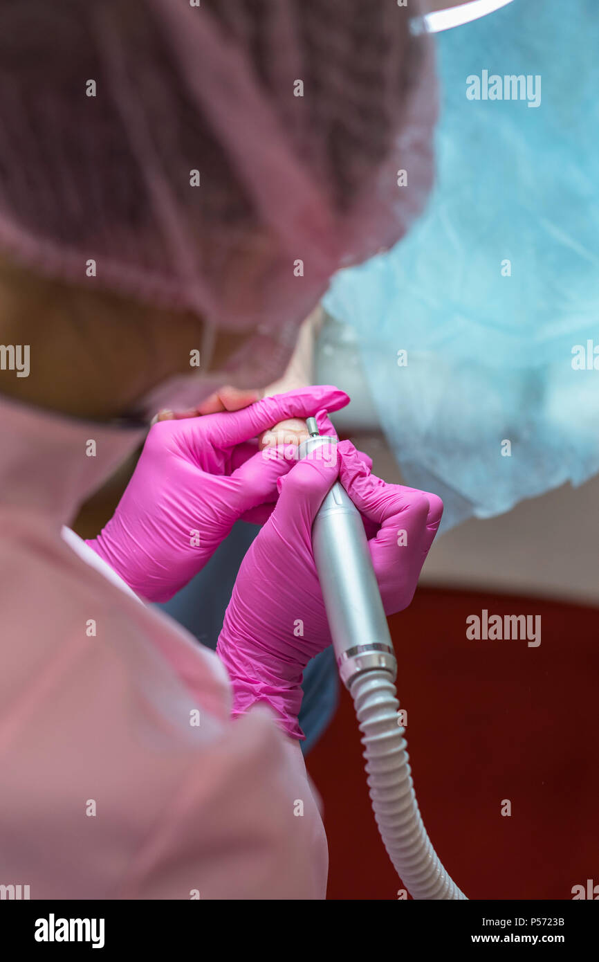 The process of pedicure in a professional beauty salon. Toned image ...