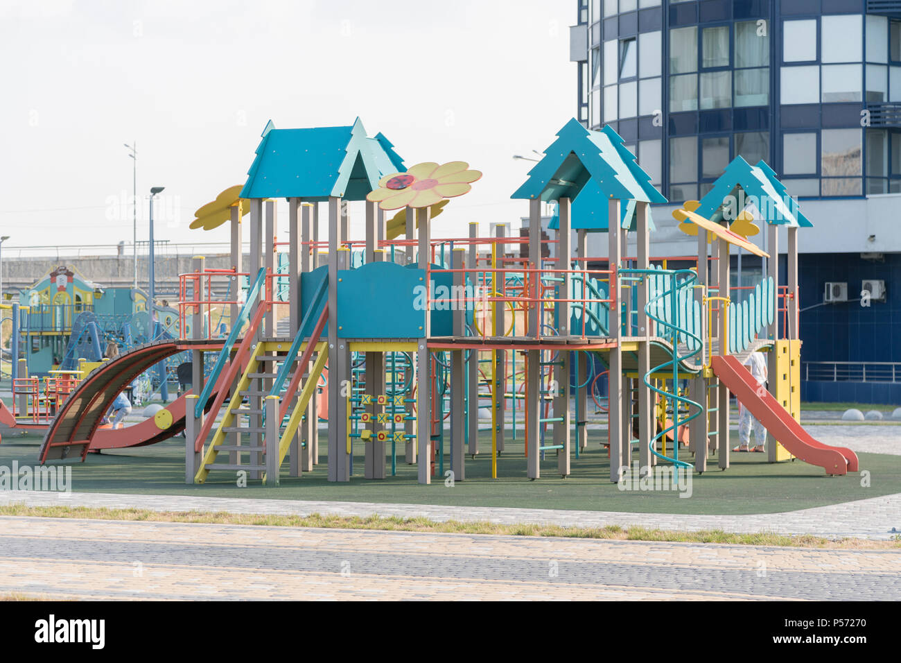 Modern children's playground near high-rise buildings Stock Photo - Alamy