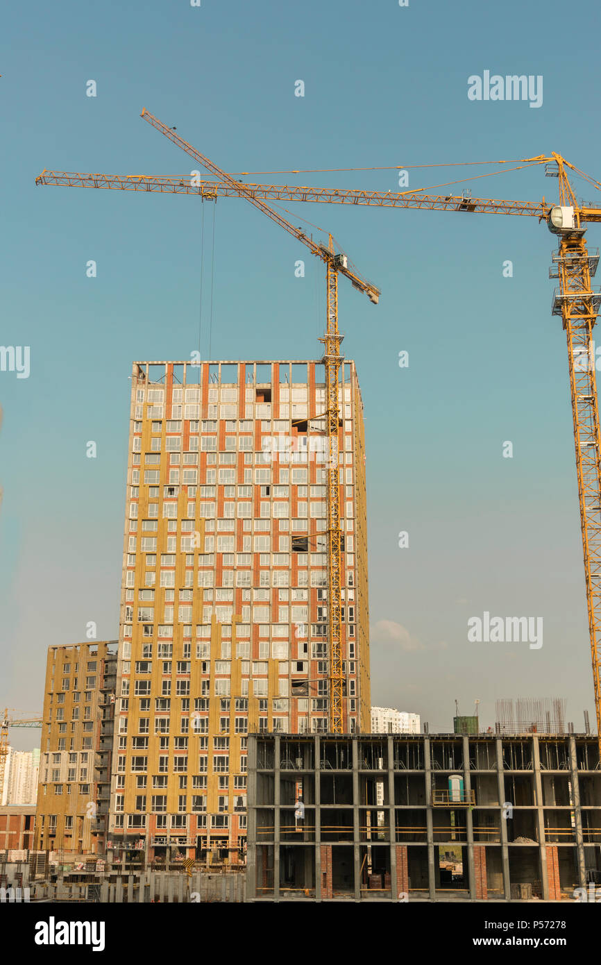 Hoisting crane and new multi-storey building. ndustrial background ...