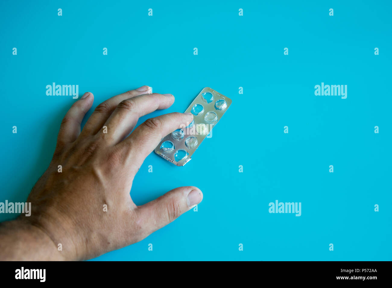 The hand reaches for the pill Stock Photo - Alamy