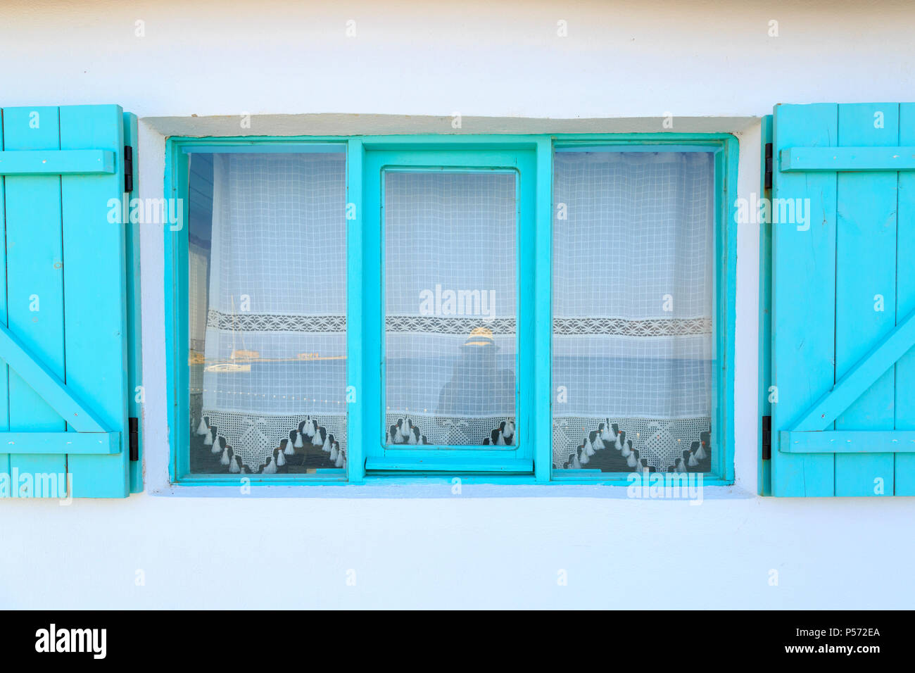 Turquoise framed windows on white wall with curtains in Datca, Turkey ...