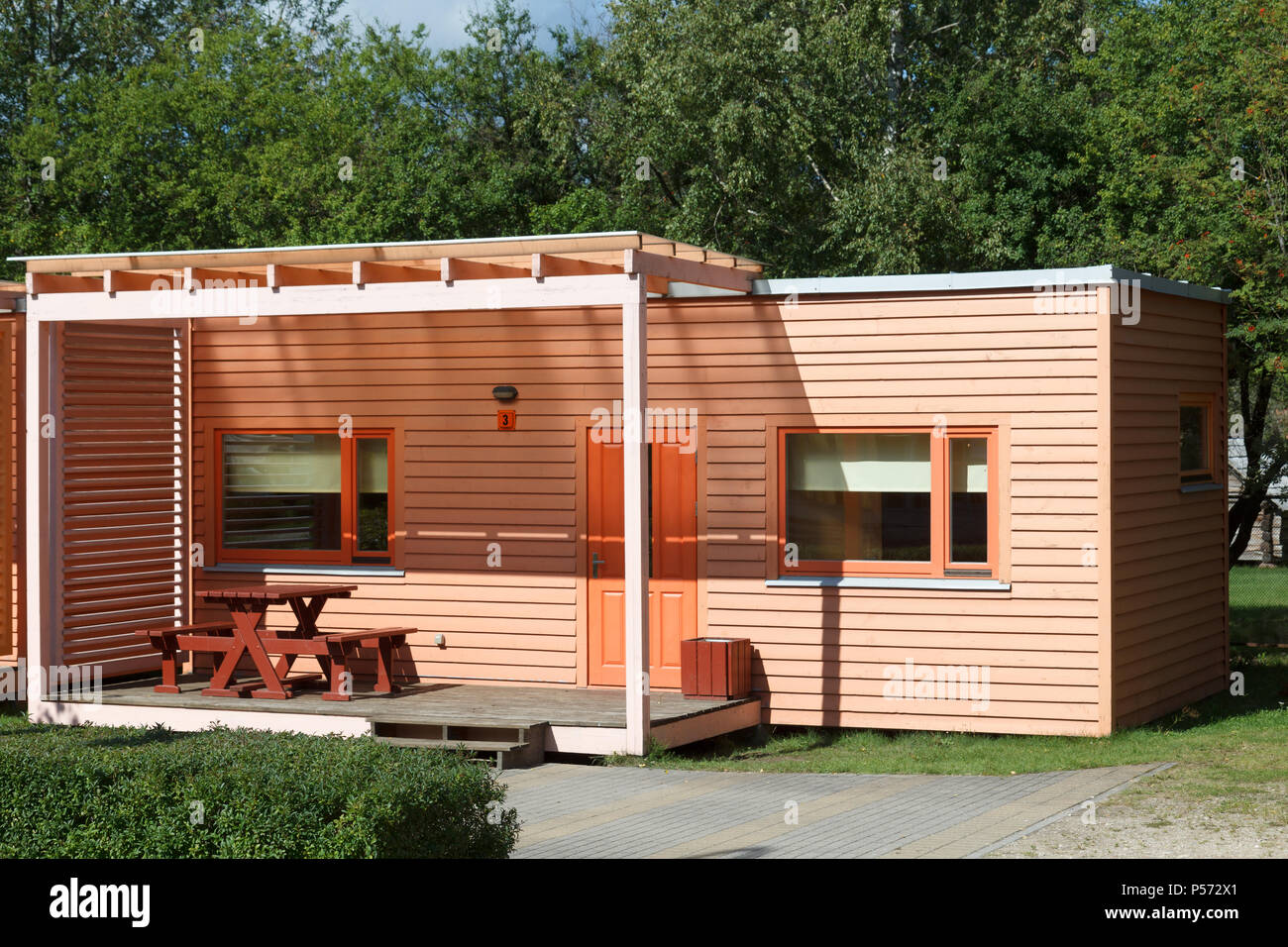 a camping cottages surrounded by green trees Stock Photo - Alamy