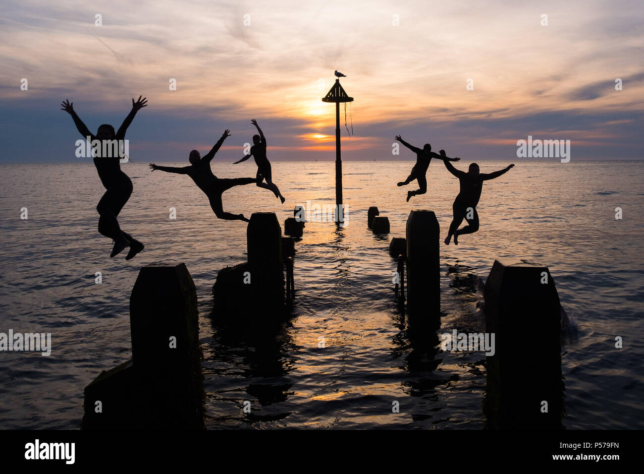 Teenagers jumping off jetty hi-res stock photography and images - Alamy