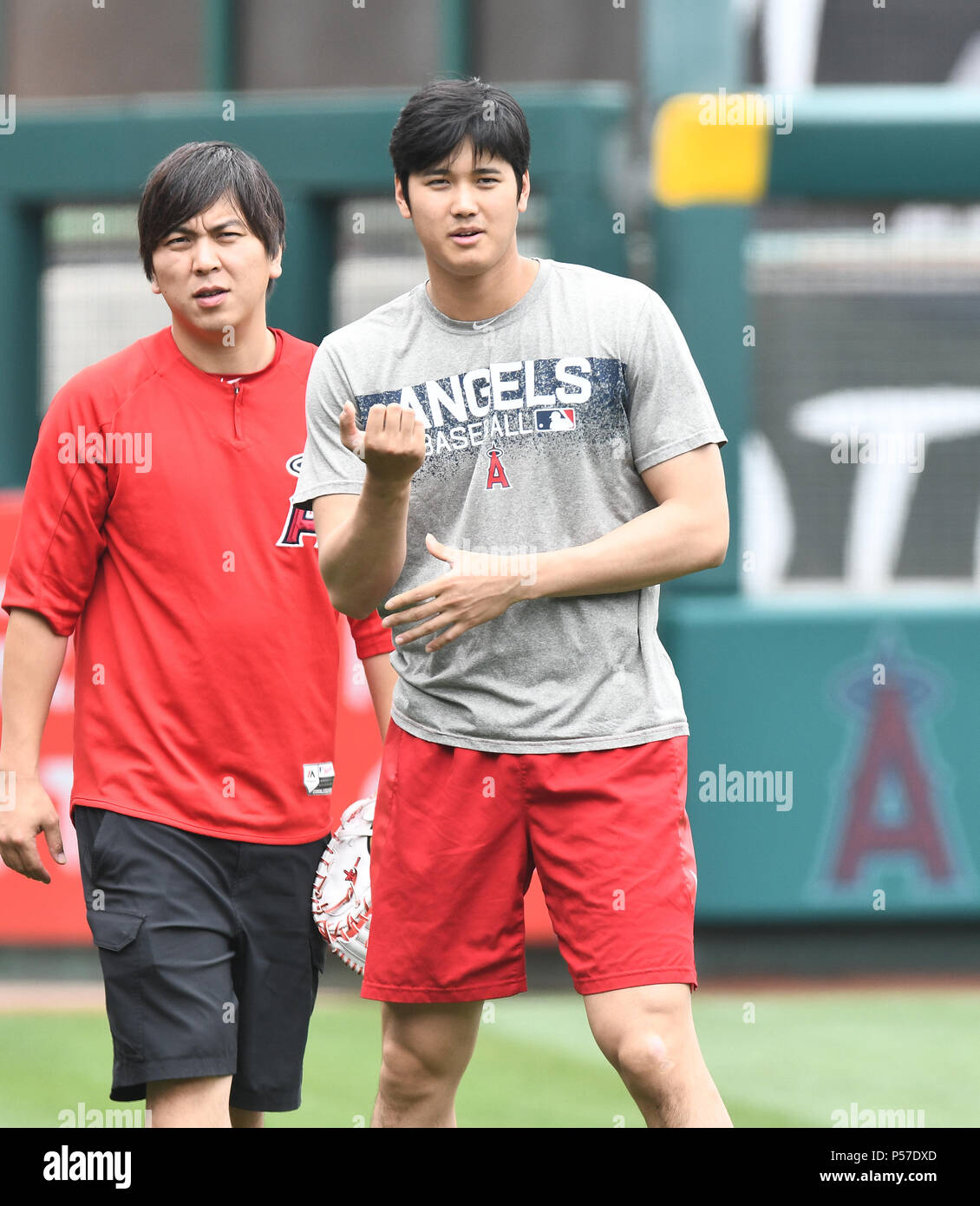 Shohei Ohtani of the Los Angeles Angels grabs his right forearm as he ...