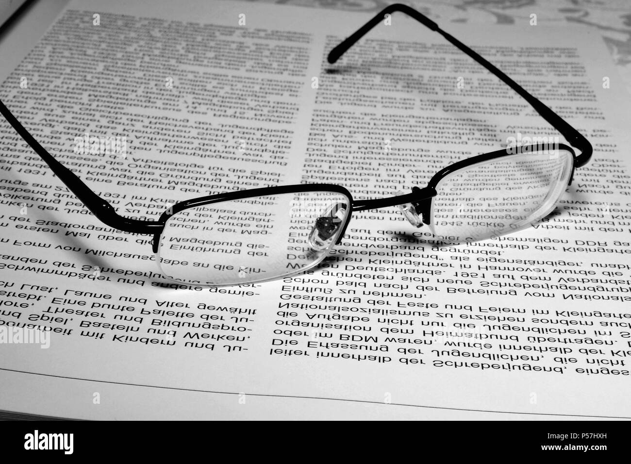 Glasses on a document Stock Photo - Alamy