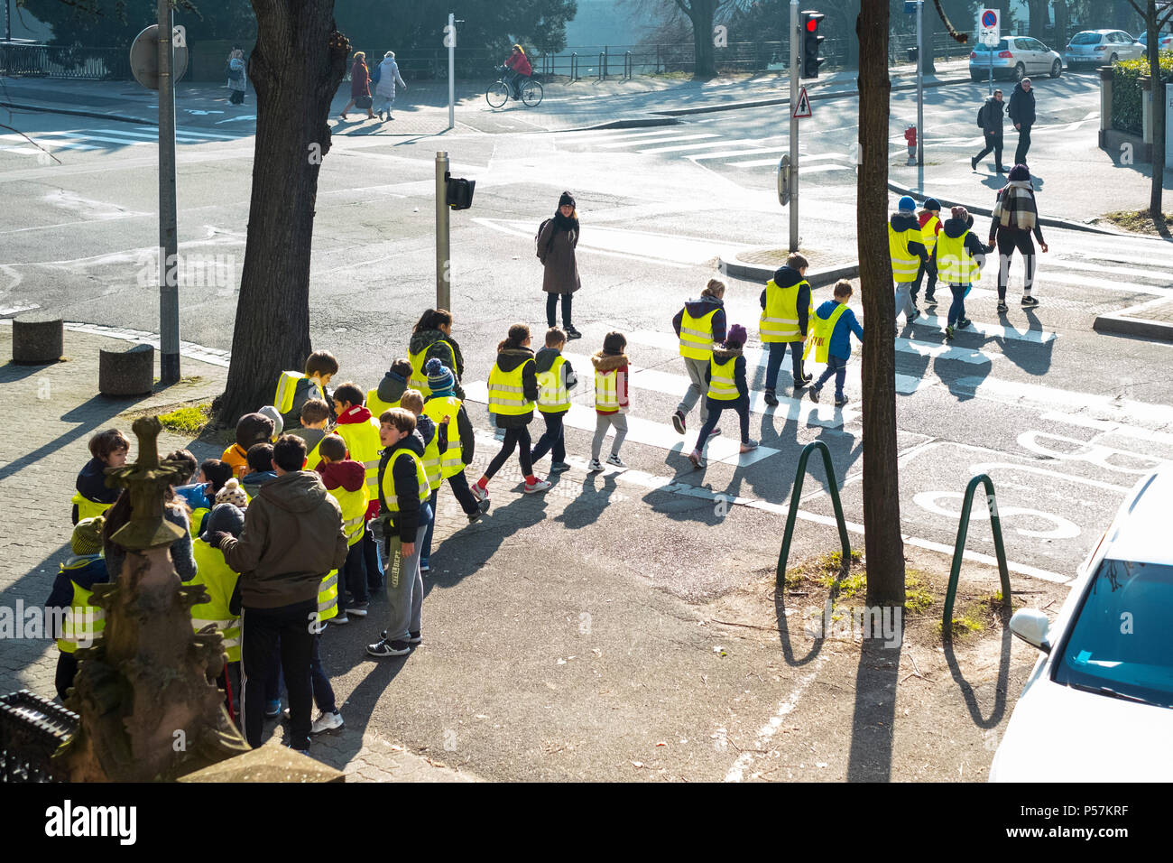 Strasbourg, young schoolchildren wearing yellow hi-vis jackets crossing ...