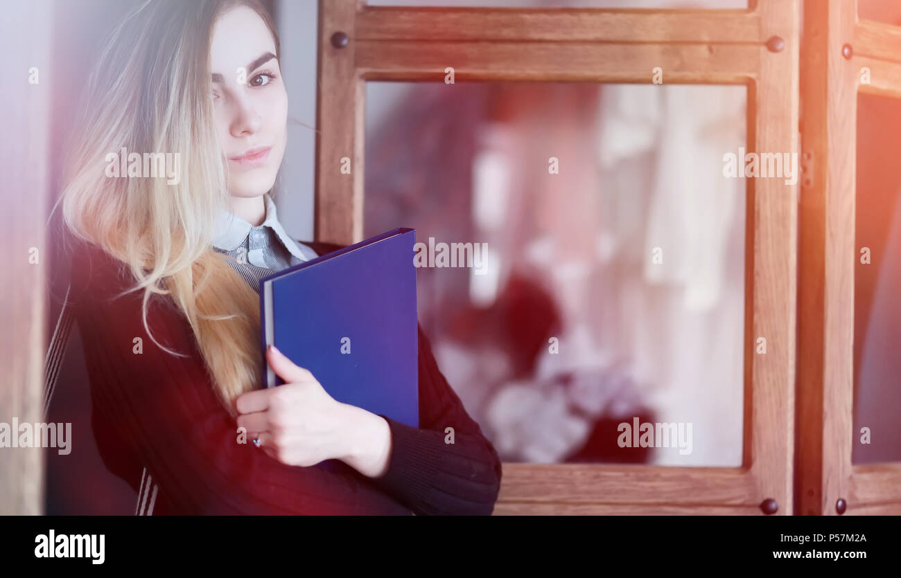 Young pretty blonde girl student before class Stock Photo - Alamy