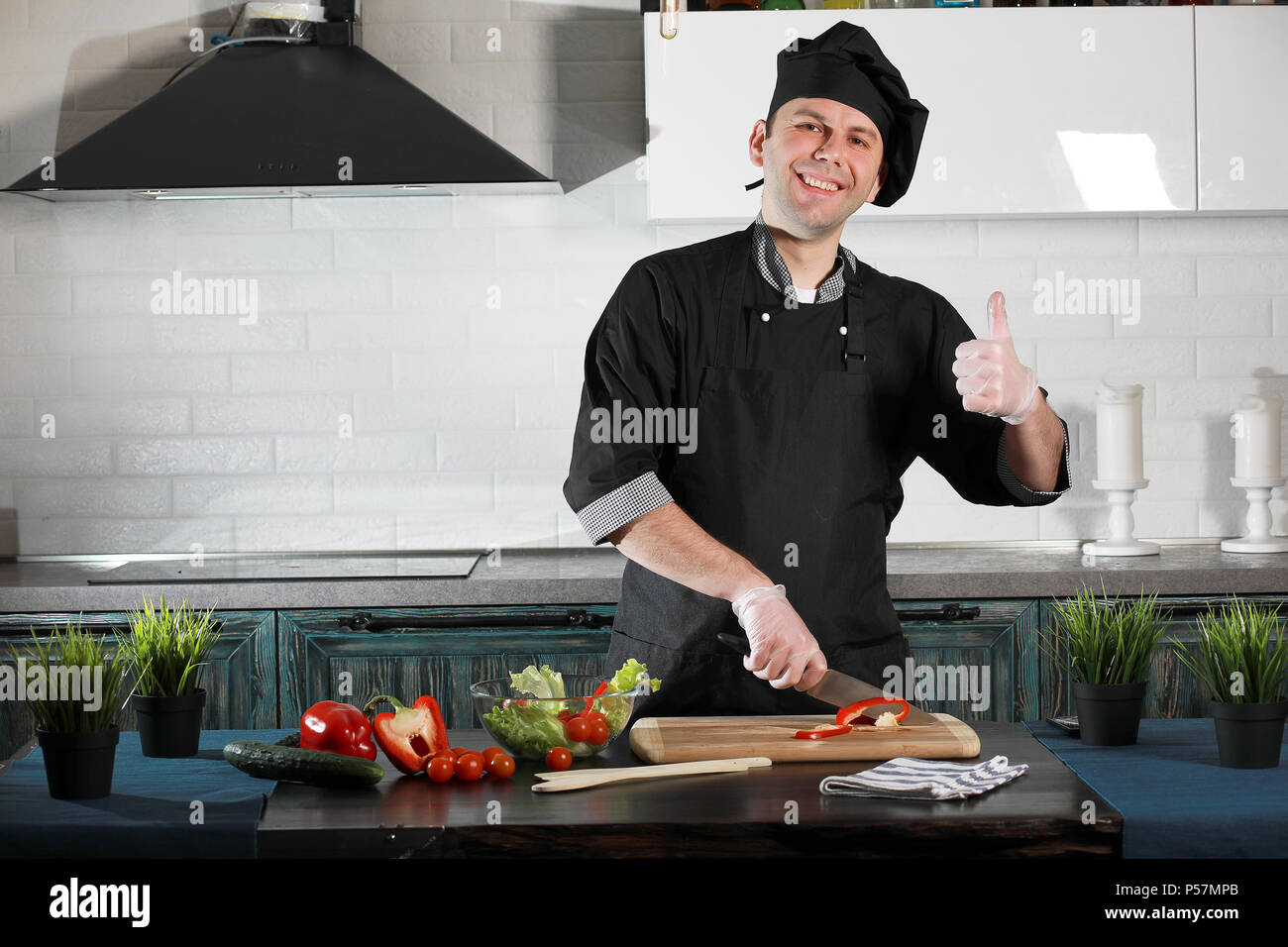 Man cook preparing food at the kitchen table of vegetables Stock Photo ...