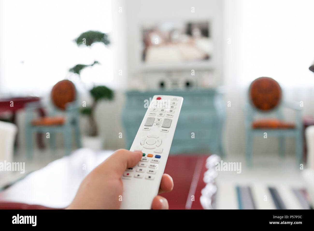 Using white remote control. Program switching or button pressing on TV ...