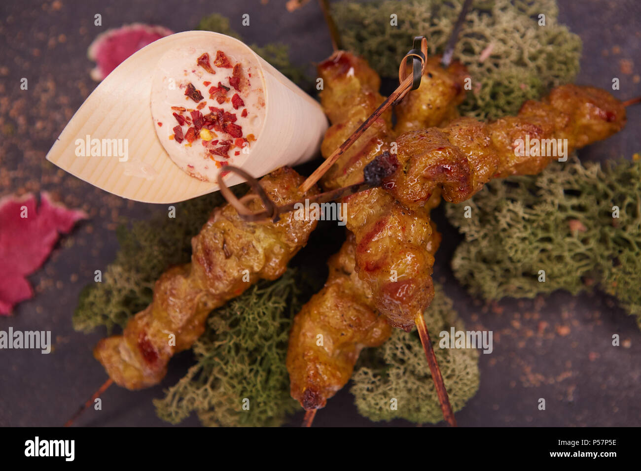 deep fried chicken tendons and sauce on white dish with wooden ...
