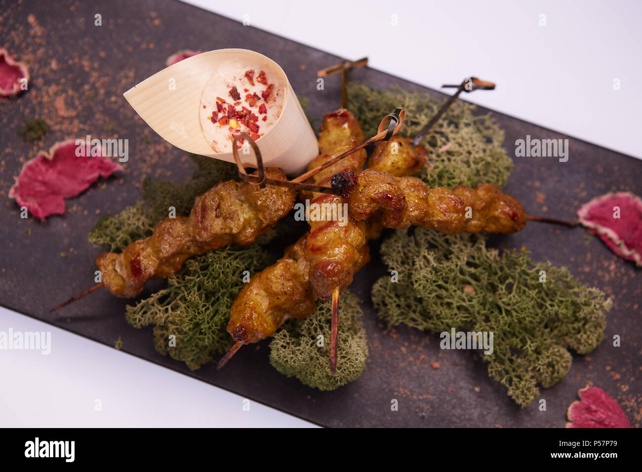 deep fried chicken tendons and sauce on white dish with wooden ...