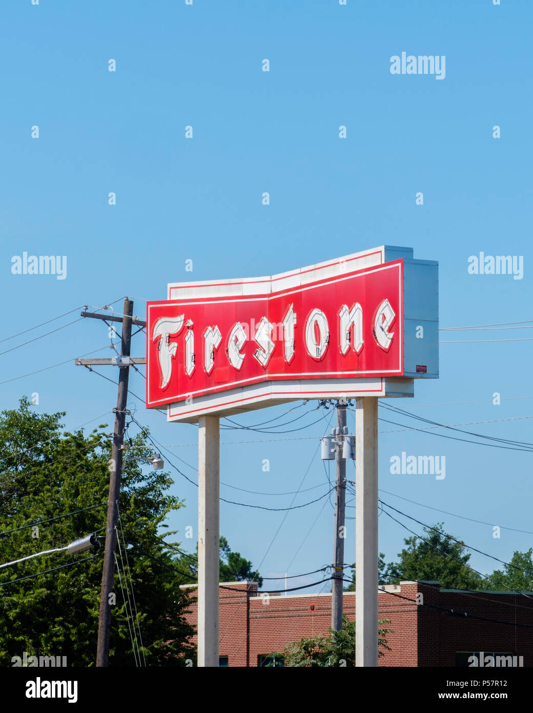 A Firestone pole sign against a blue sky with copy space in Norman ...