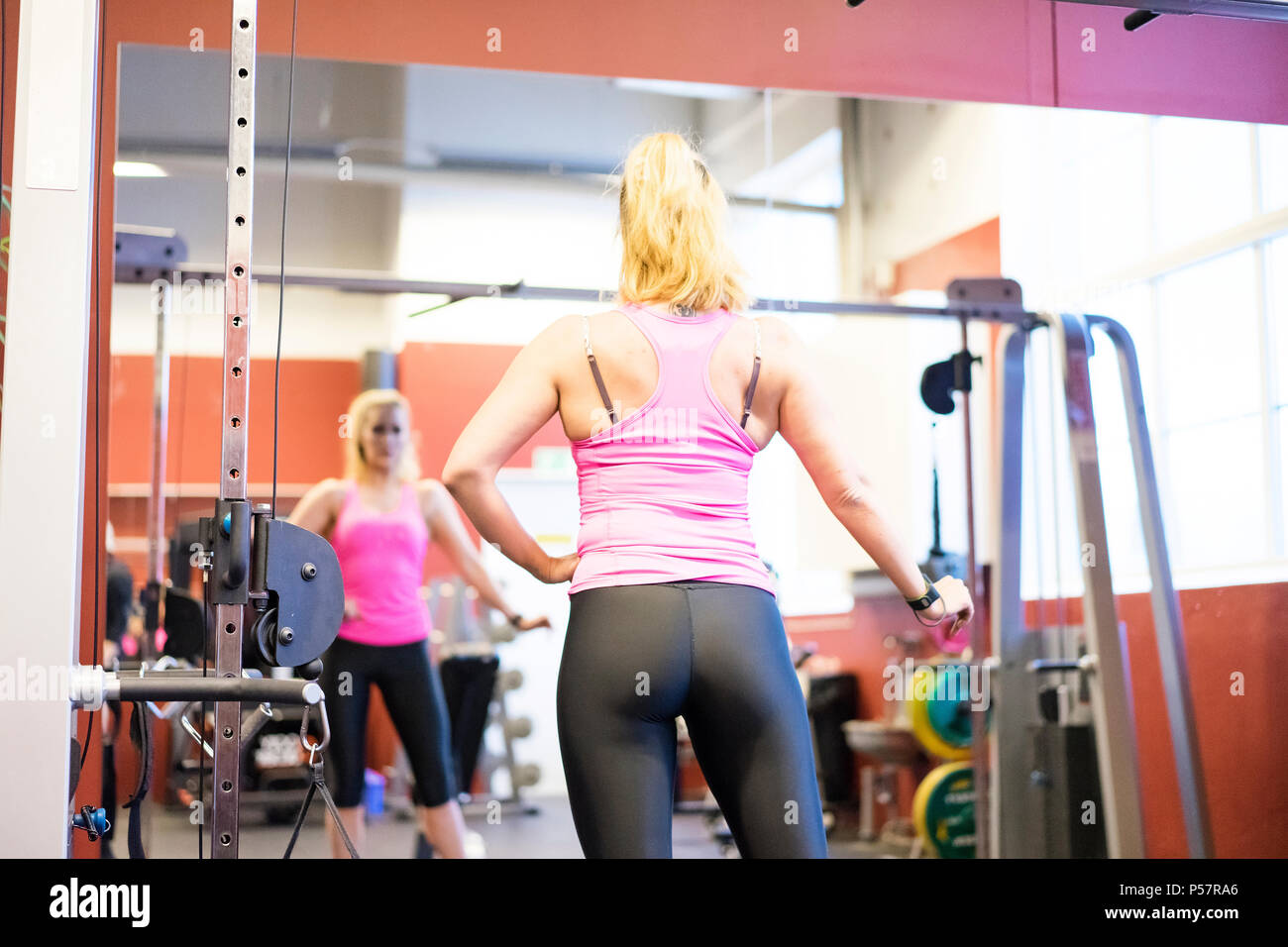 Caucasian blonde Scandinavian fitness girl training at gym. Strong ...