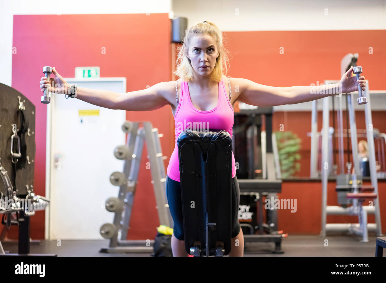 Caucasian blonde Scandinavian fitness girl training at gym. Strong ...