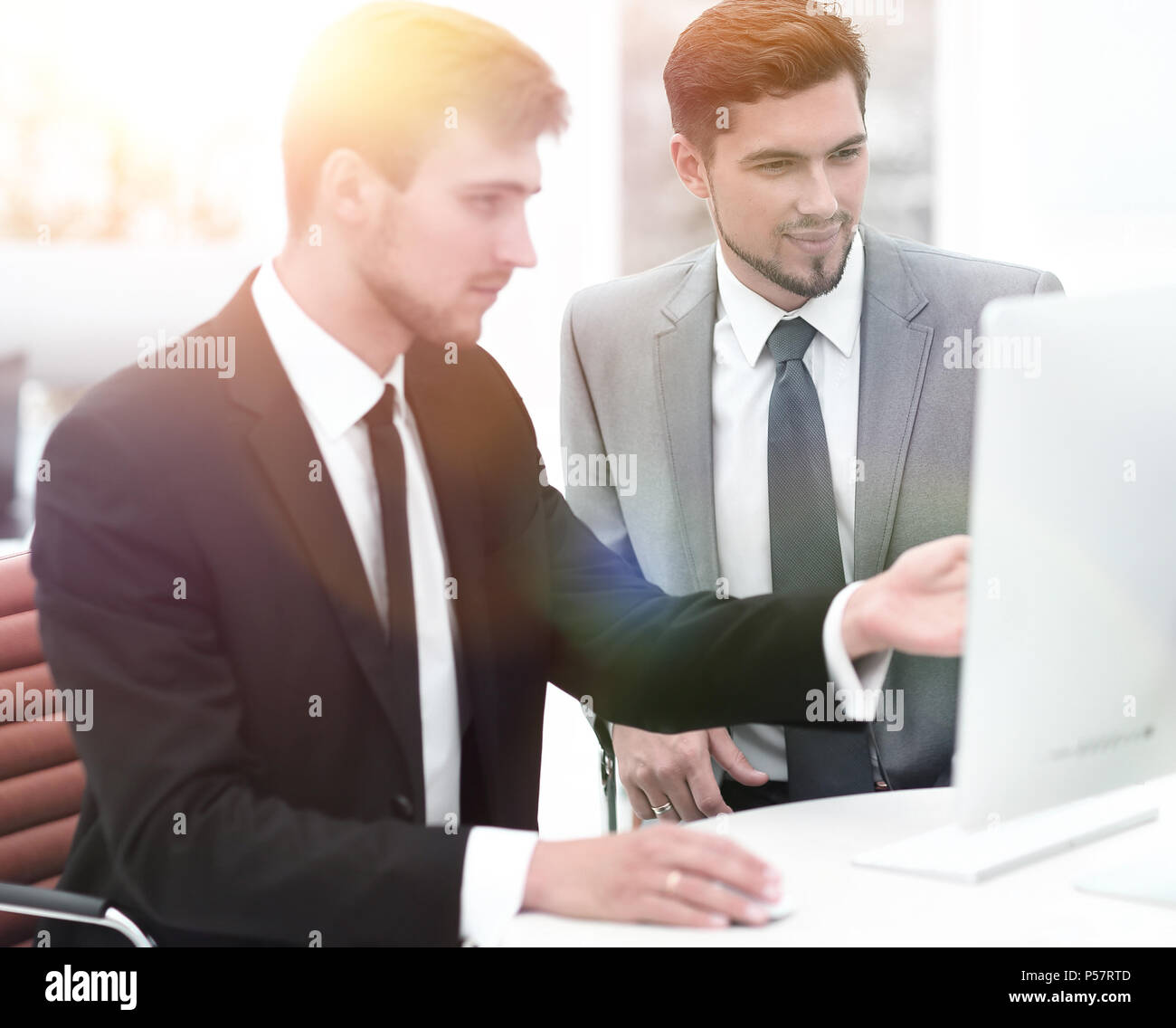 employees are talking sitting behind a Desk. office life Stock Photo ...