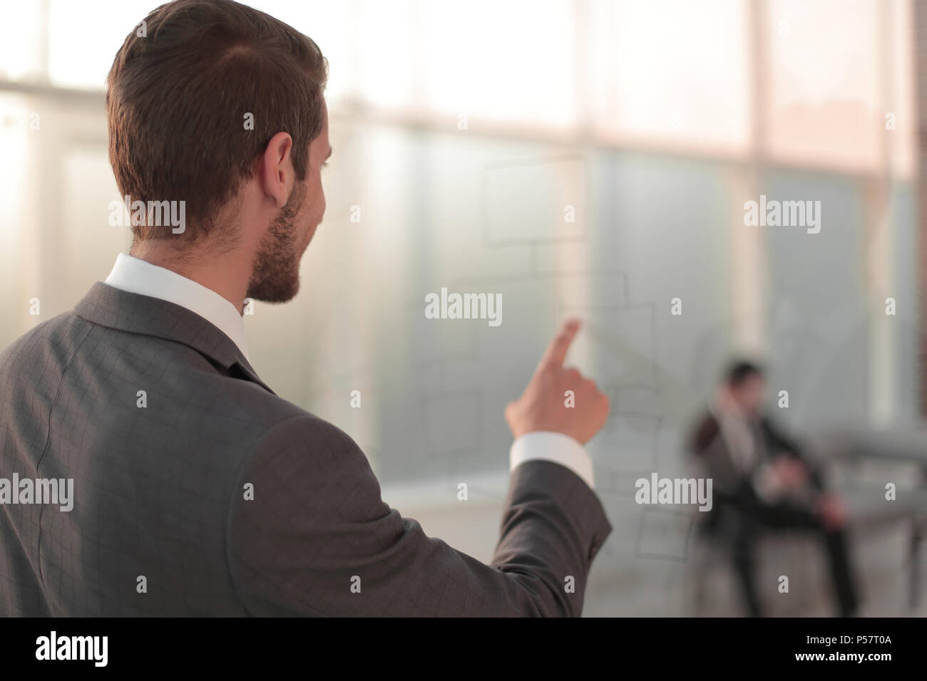 rear view.businessman pointing his finger at the office window Stock ...