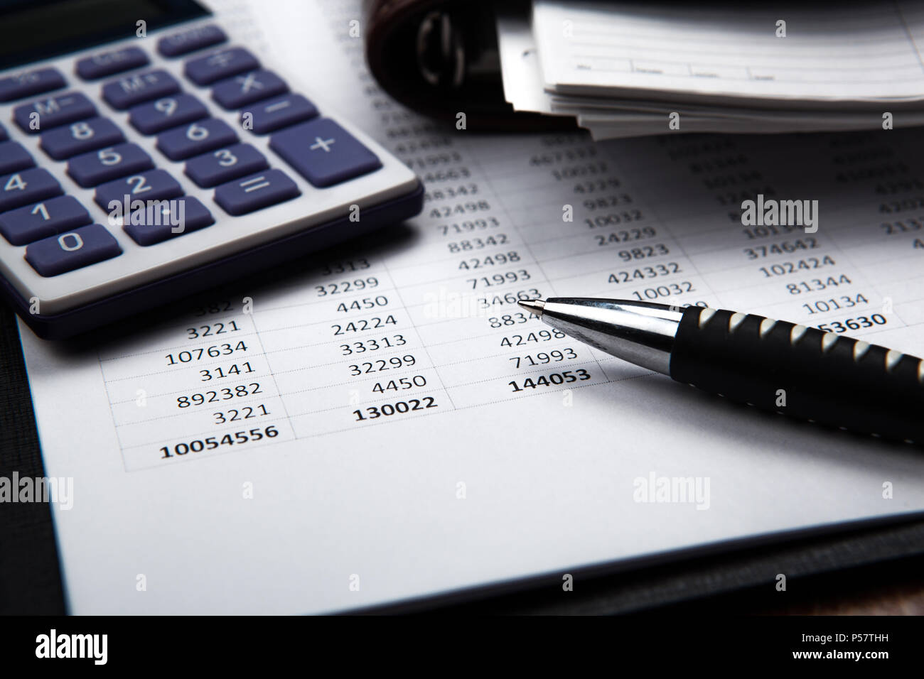 pen on background of calculator and accounting papers Stock Photo - Alamy