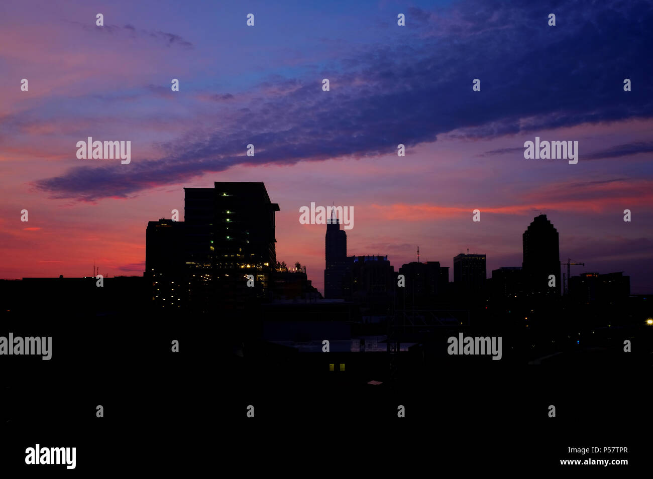 The skyline of Raleigh North Carolina back lit by the pink early ...