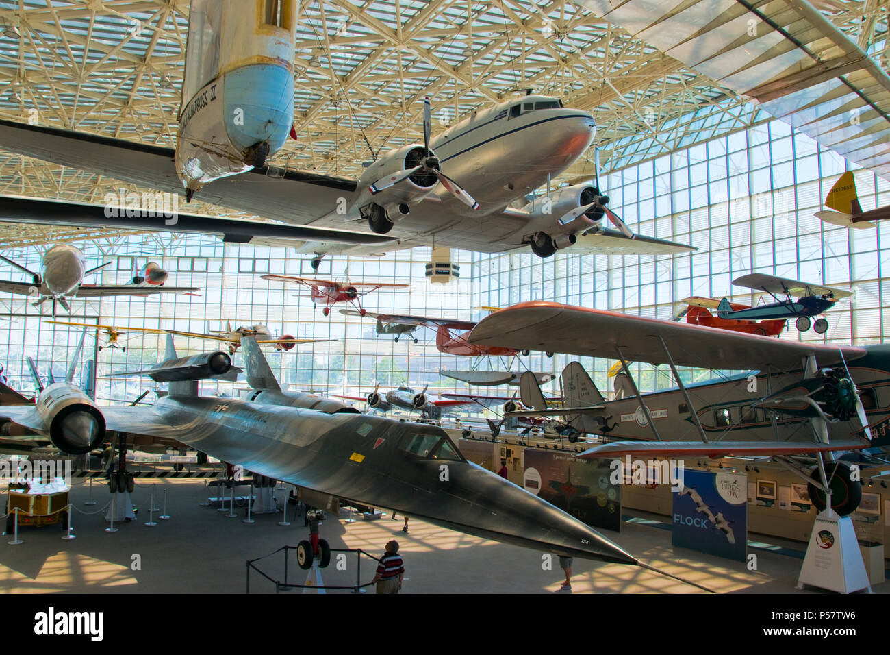 A 1940 Douglas DC-3 airliner hangs above a Lockheed M-21 Blackbird at ...