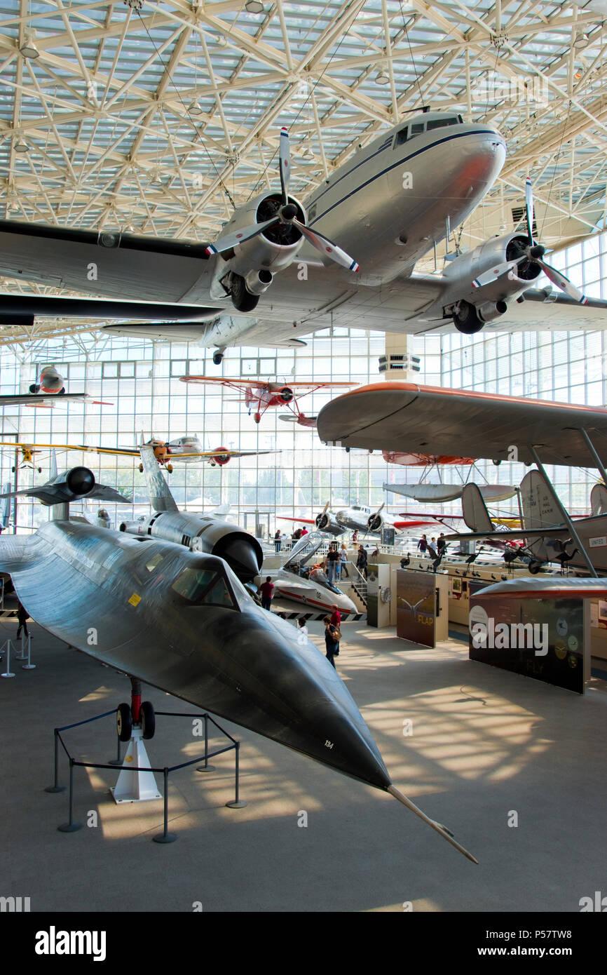 A 1940 Douglas DC-3 airliner hangs above a Lockheed M-21 Blackbird at ...
