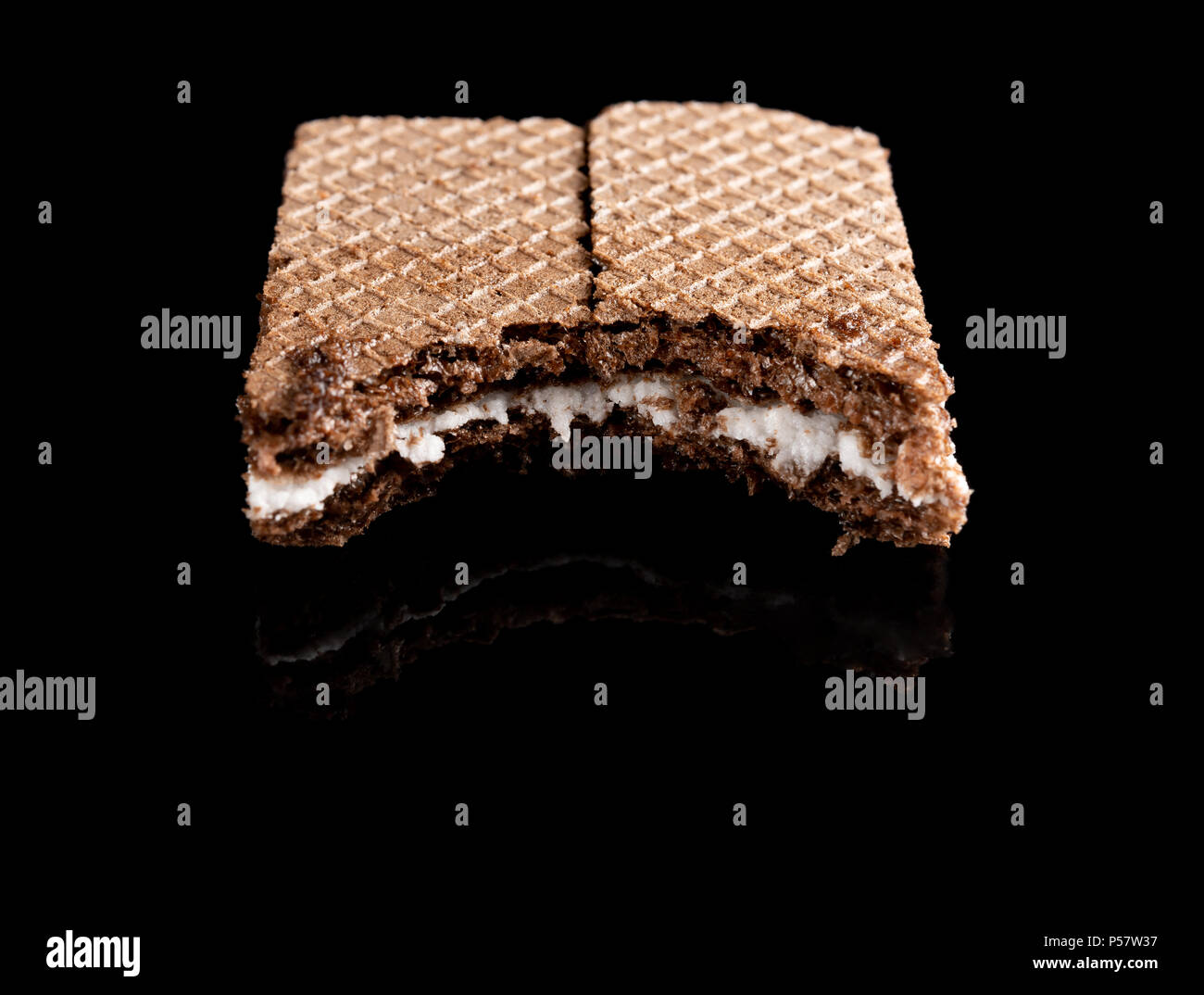 vanilla flavor wafer blocks with a big bite on black background Stock ...