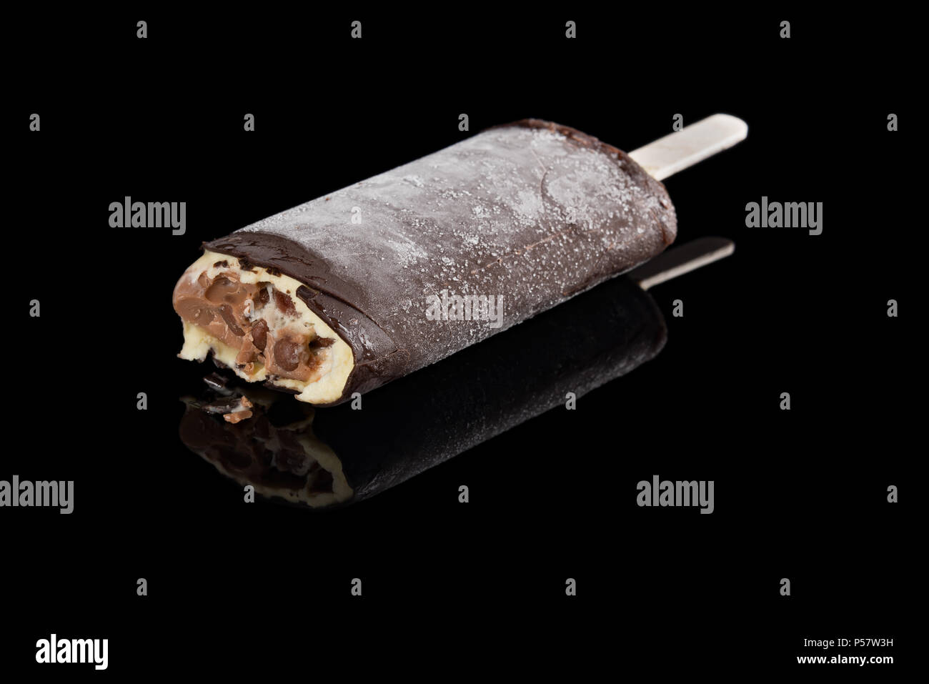 chocolate outer popsicle and beans inside with some bites on a black ...