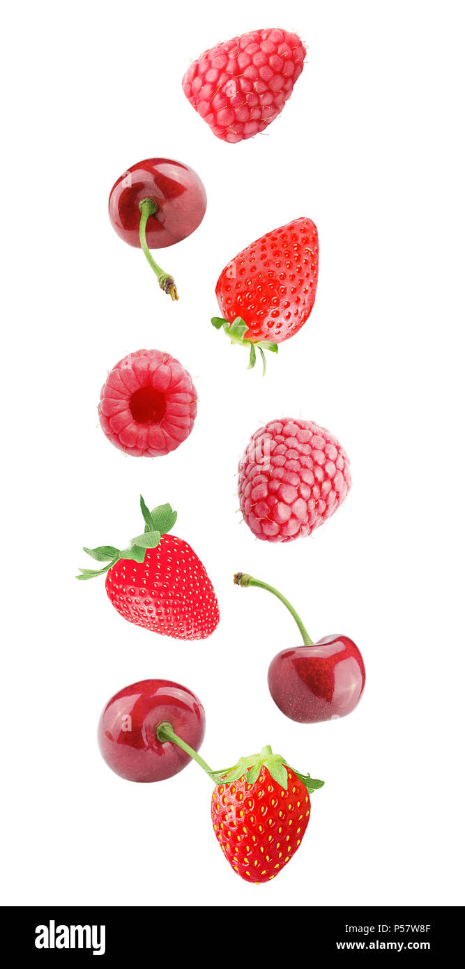 Isolated flying mixed red berries. Falling cherry, strawberry and ...