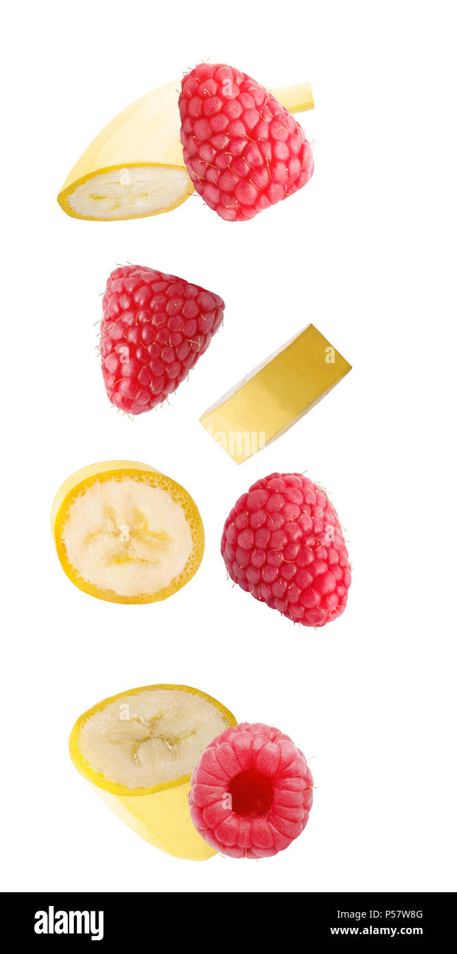 Isolated flying fruits. Falling banana and raspberry fruits isolated on ...