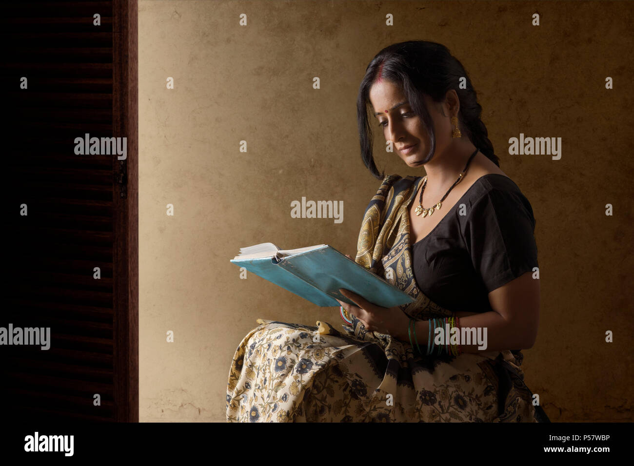Indian rural woman reading book Stock Photo - Alamy