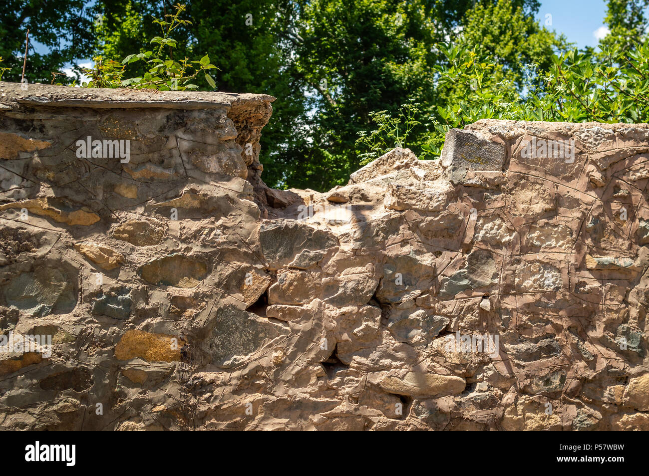 A portion of the top of a stone wall is broken Stock Photo - Alamy