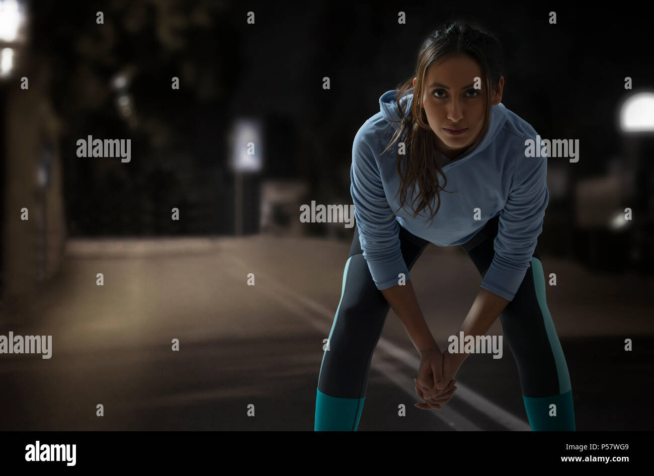 Young woman running on road hi-res stock photography and images - Alamy