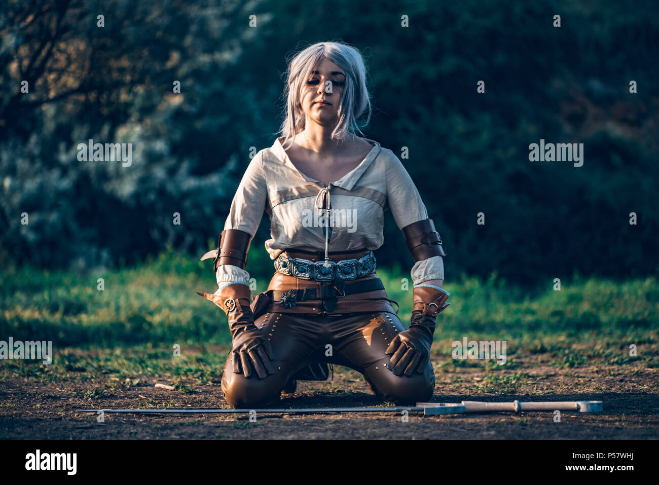 Fantasy cosplay beautiful Witcher girl with sword Stock Photo - Alamy