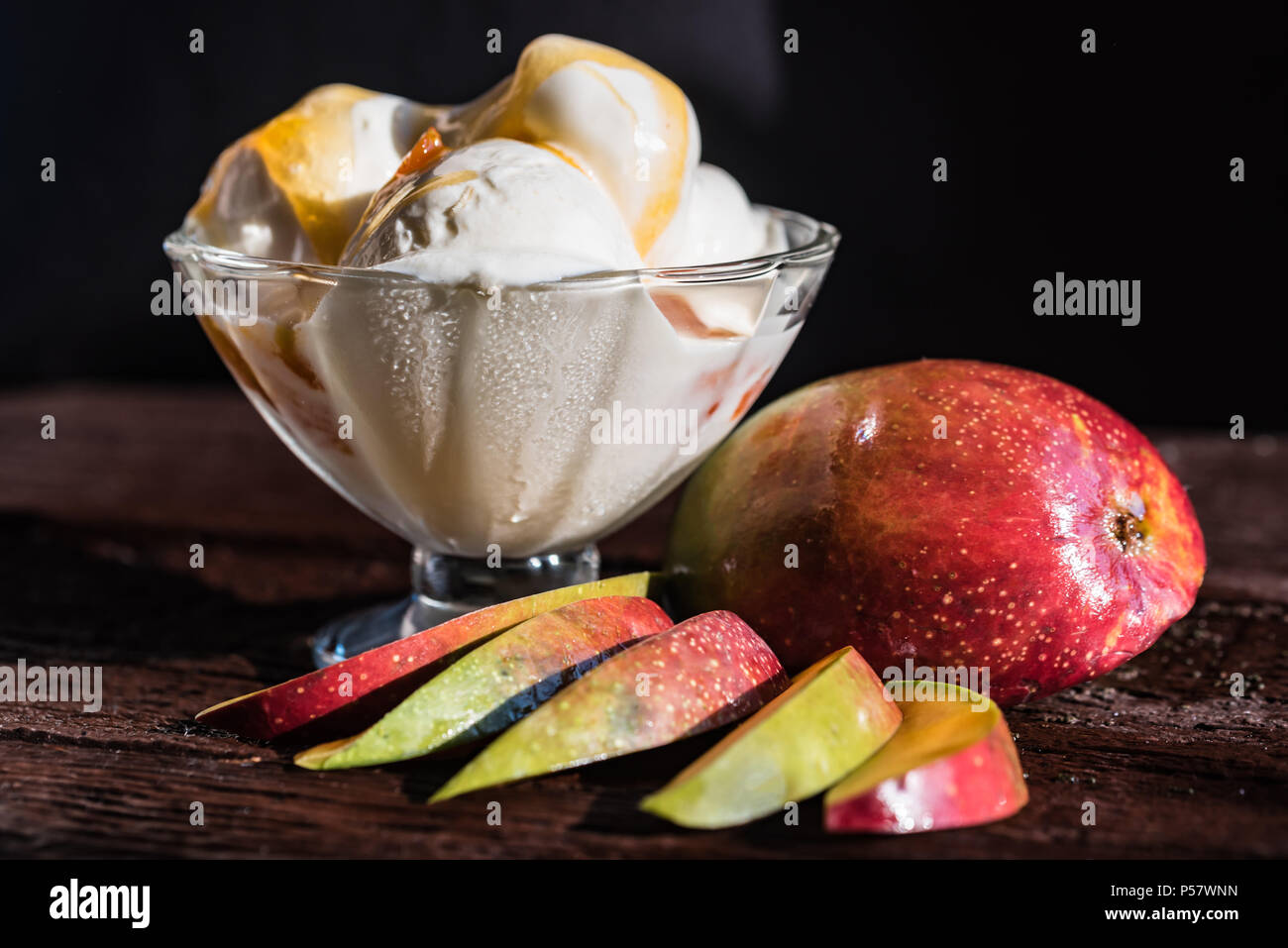 Caramel sauce ice cream and fresh mango fruit Stock Photo - Alamy